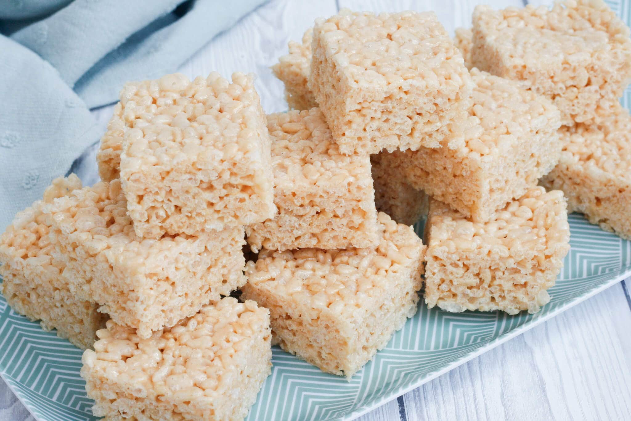 Rice Krispie treats on a serving plate.